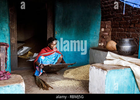 Rural Indian village woman sifting Finger Millet flour / Ragi flour ...