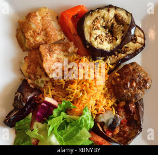 grilled fish with rice and vegetables on a black background Stock Photo ...