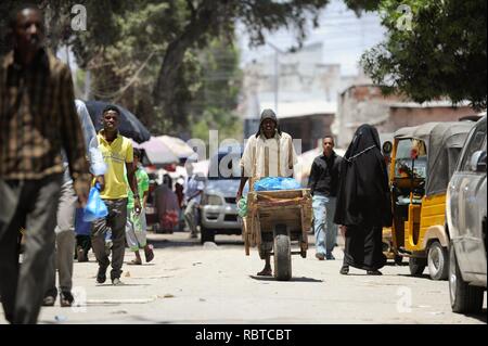 A Somali man walks down a street in Kismayo, Somalia, during a patrol ...