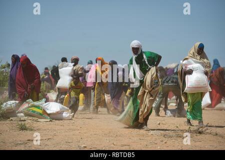 People fight over food in a food distribution center run by a private ...