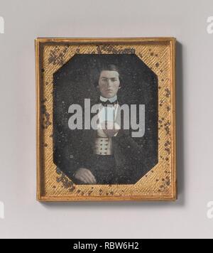-Young Man with Hand Tucked in Vest Stock Photo - Alamy