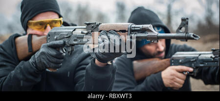 Large team, group of civilian people have action training with rifle ...