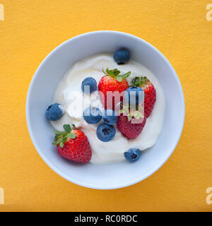 strawberries fresh on yellow background / ripe red strawberry picking ...
