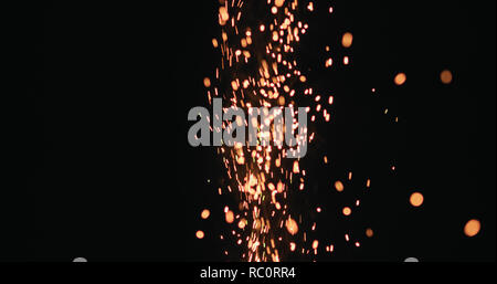 hot sparks slowly falling from above black background, wide photo Stock ...