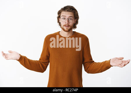 Confused man with raised eyebrows Stock Photo - Alamy
