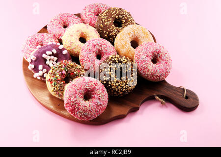 assorted donuts with chocolate frosted, pink glazed donuts Stock Photo ...