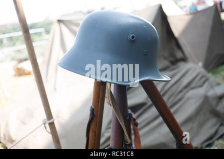 Rifles pyramids with ammunition and german steel helmet, First World ...