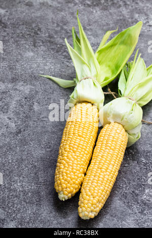 Corn kernels and cobs on grey background Stock Photo - Alamy