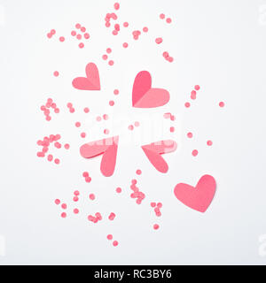 A top view of white paper hearts on a red background Stock Photo - Alamy
