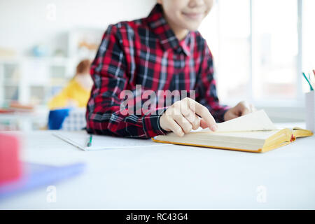 Little girl turning page Stock Photo - Alamy
