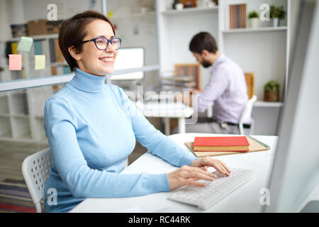 Typing at workplace Stock Photo - Alamy