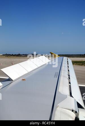 Wing of a plane with the flaps and slats deployed to reduce the speed ...