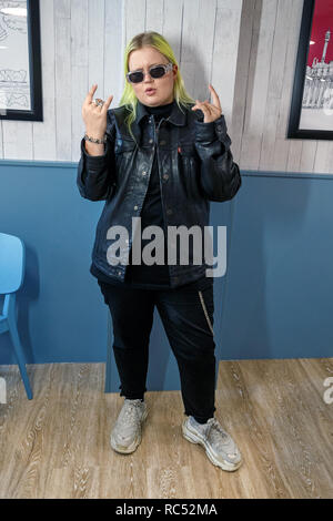 Alma, pop singer from Finland, poses for photographs in the lobby of a ...