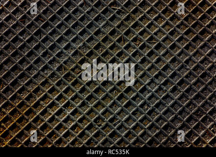 A close up of a rusted metal grate with a diamond like pattern Stock ...