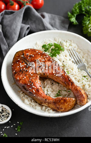Cooked salmon fish on homemade ceramic plate served with white ...