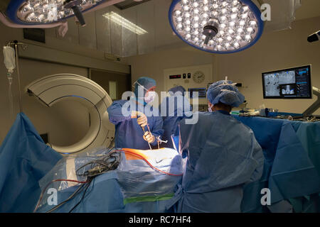 A modern operating room, surgeons and doctors doing an oncological ...
