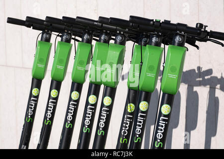 Lime-S rental scooters line the street along Centennial Olympic Park in ...