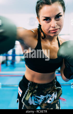 Close-up of female boxer punching athlete in boxing ring Stock Photo ...