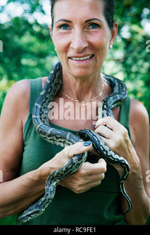 Woman with a snake around her neck Stock Photo - Alamy