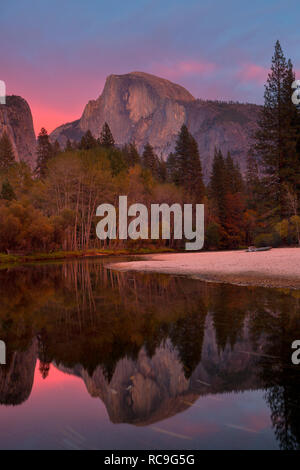 Half Dome rises above the the Merced River and the valley floor in ...