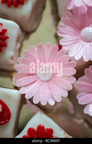 Colorful petit fours with flower decoration Stock Photo - Alamy