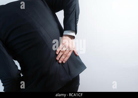 Man bending over, holding lower back, cropped view Stock Photo ...
