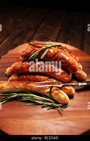 Grilled sausages with spices and herbs on a black background with copy ...