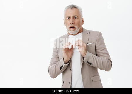 Portrait of scared and timid man in christmas sweater, looking ...