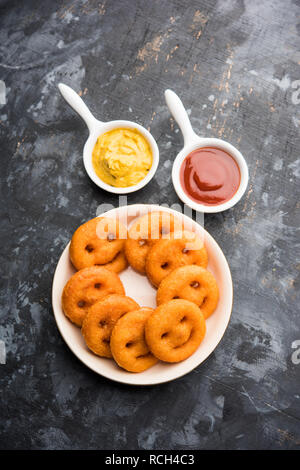Crunchy potato smiling face chips or fried smile faced snacks served ...