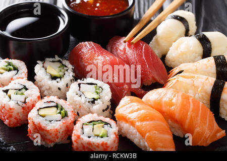Close-up of two Japanese uramaki sushi rolls with eel, cream cheese ...