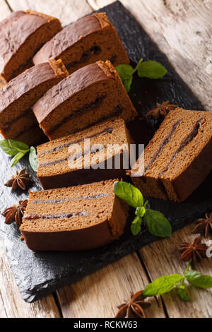 Polish festive cake piernik with plum jam close-up on the table ...