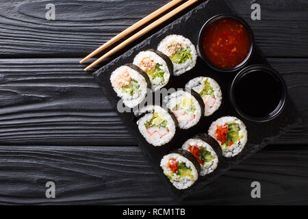 Tasty sushi rolls maki served on wooden cafe table. Close up shot of ...