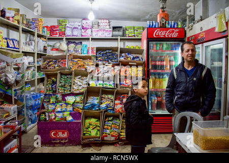 Palestinian refugees are seen in a shop at the Dheisheh refugee camp ...