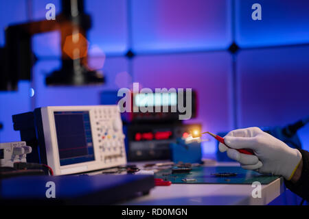 Check electronics device in industrial lab Stock Photo - Alamy