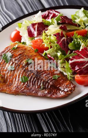 Fresh grilled fish served with salad and lemon in Mediterranean style ...