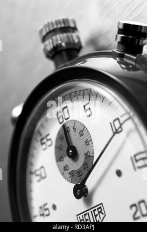 A black and white image of a clock with numbers falling off showing the ...