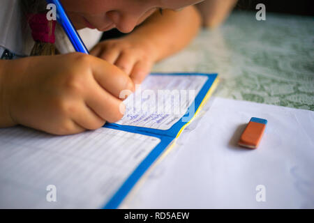 Studing human writing writing in a notebook Stock Photo - Alamy