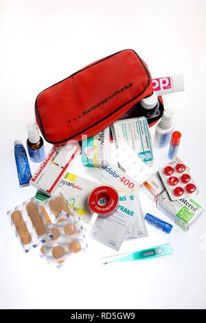 First aid kit - tablets, thermometer on the table on a white background ...