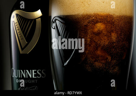 Close up of the Guinness beer logo plate mounted on a beer tap, blurred ...