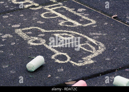 Boy with chalk drawing car Stock Photo - Alamy