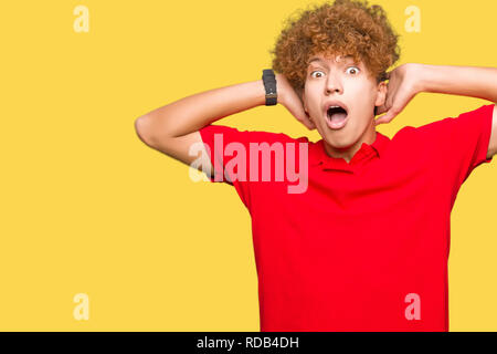 Shocked and scared redhead man screaming, open mouth and staring ...
