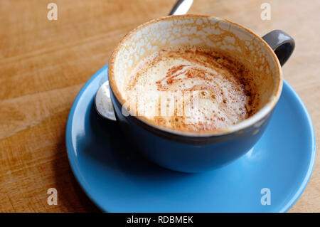 Cup of coffee on a blue table Stock Photo - Alamy