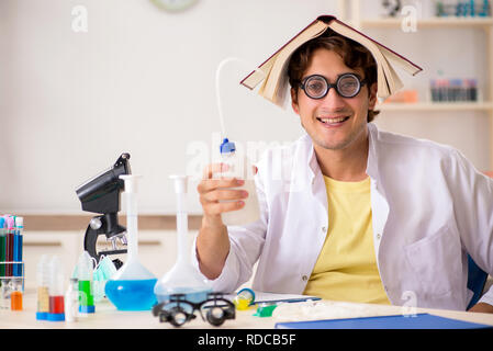 Funny crazy chemist doing experiments and tests Stock Photo - Alamy
