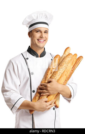 Young baker holding bread and baguette smiling at a customer in the ...