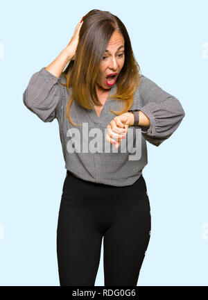 Middle age hispanic woman getting vaccine showing arm with band aid ...