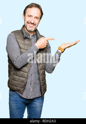 Portrait of attractive cheerful amazed grey haired man searching copy ...