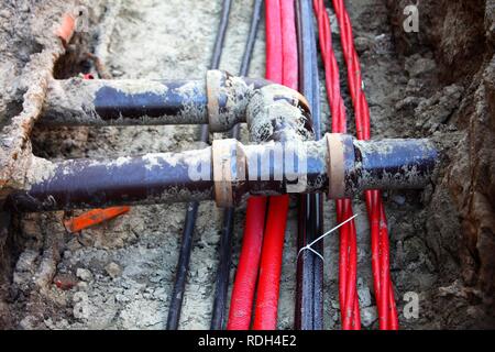 Installation of various cables in a building site, power lines and ...
