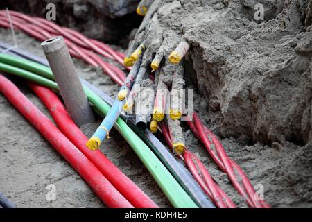 Installation of various cables in a building site, power lines and ...