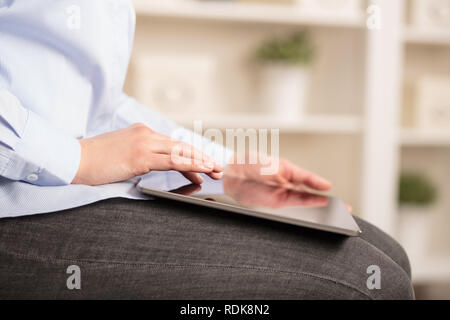 Business woman below chest using tablet in a homey environment Stock ...