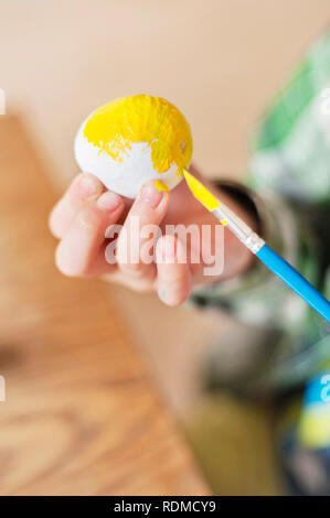 Human hand holding a brush and painting wood Stock Photo - Alamy
